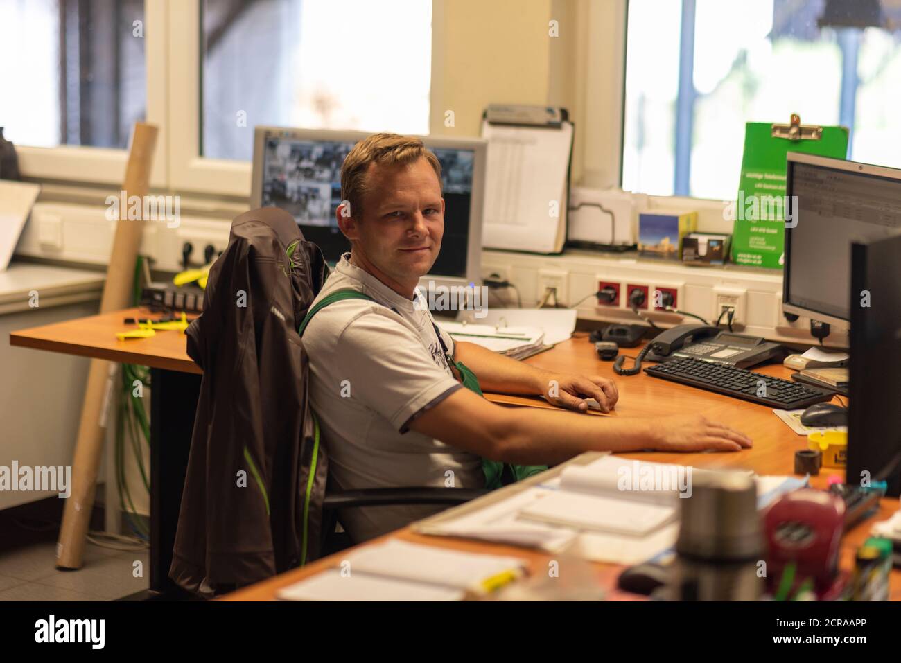 Farmer, farmer, rancher, sits in front of the computer in his office ...