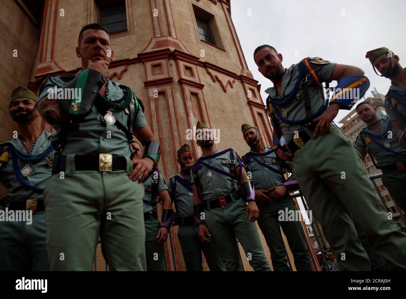 Spanish legionnaires stand before carrying a statue of the Christ of ...
