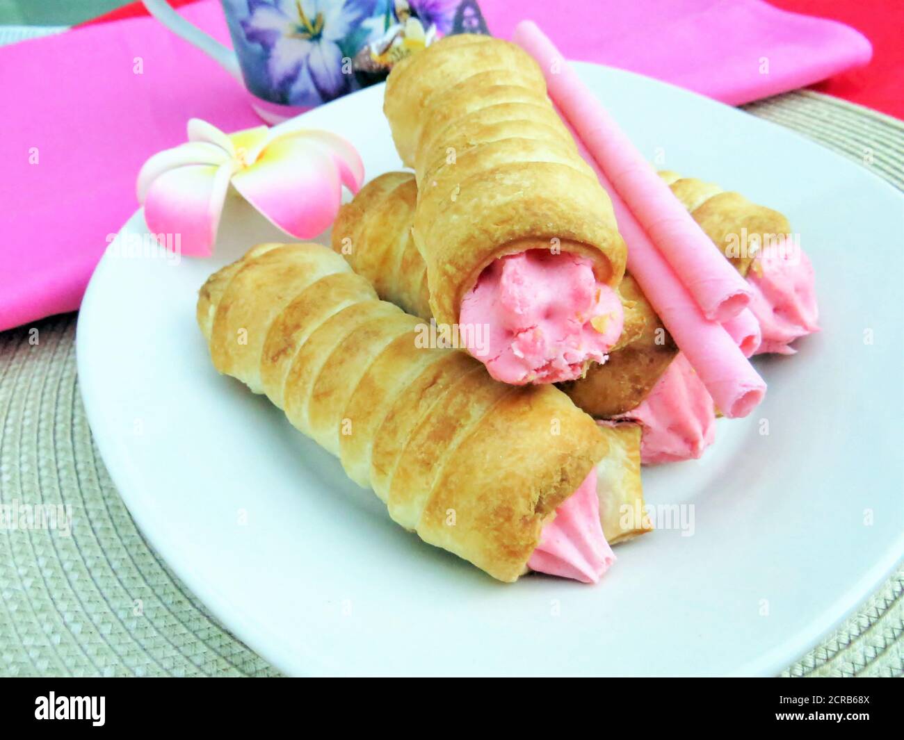 Cup of coffee and strawberry cream filled horns Stock Photo - Alamy