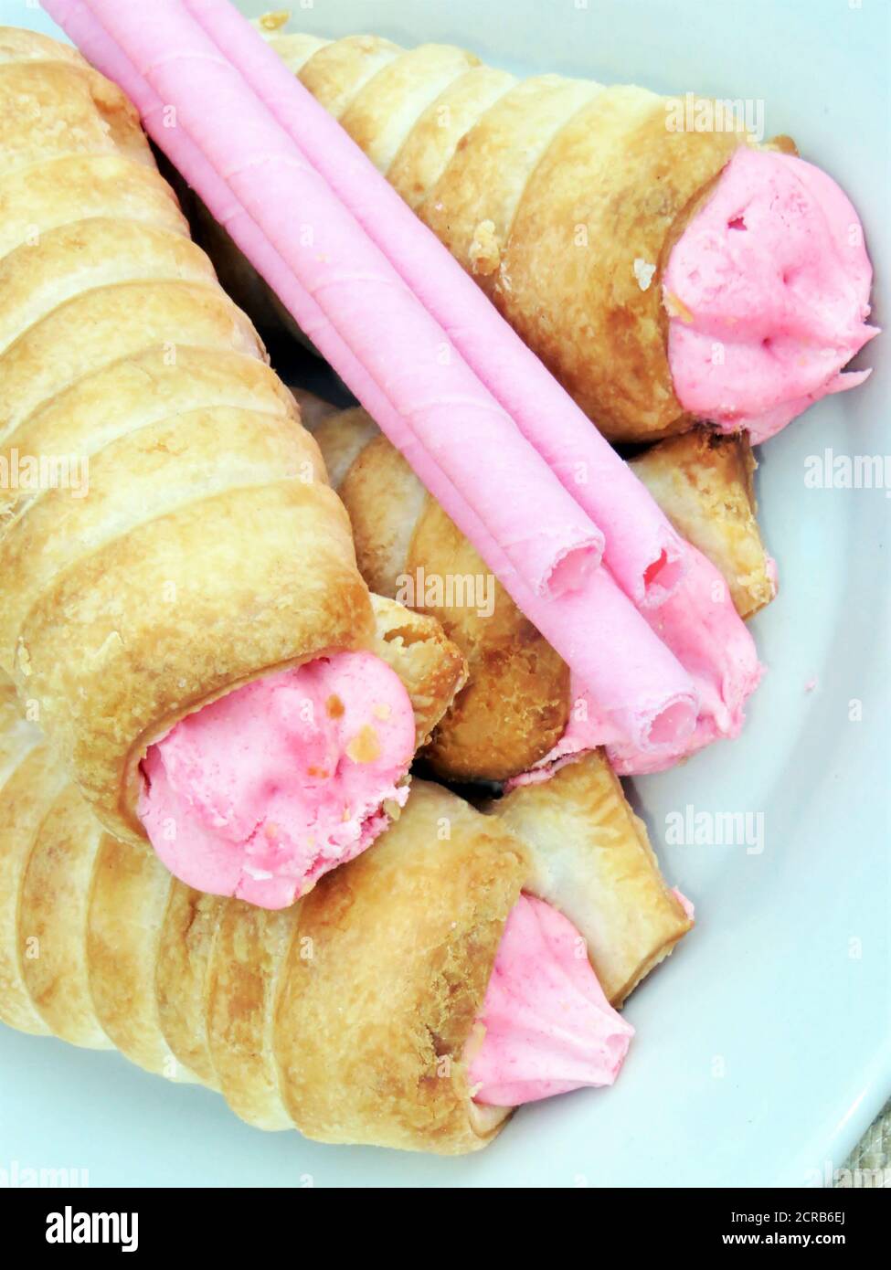 Cup of coffee and strawberry cream filled horns Stock Photo - Alamy