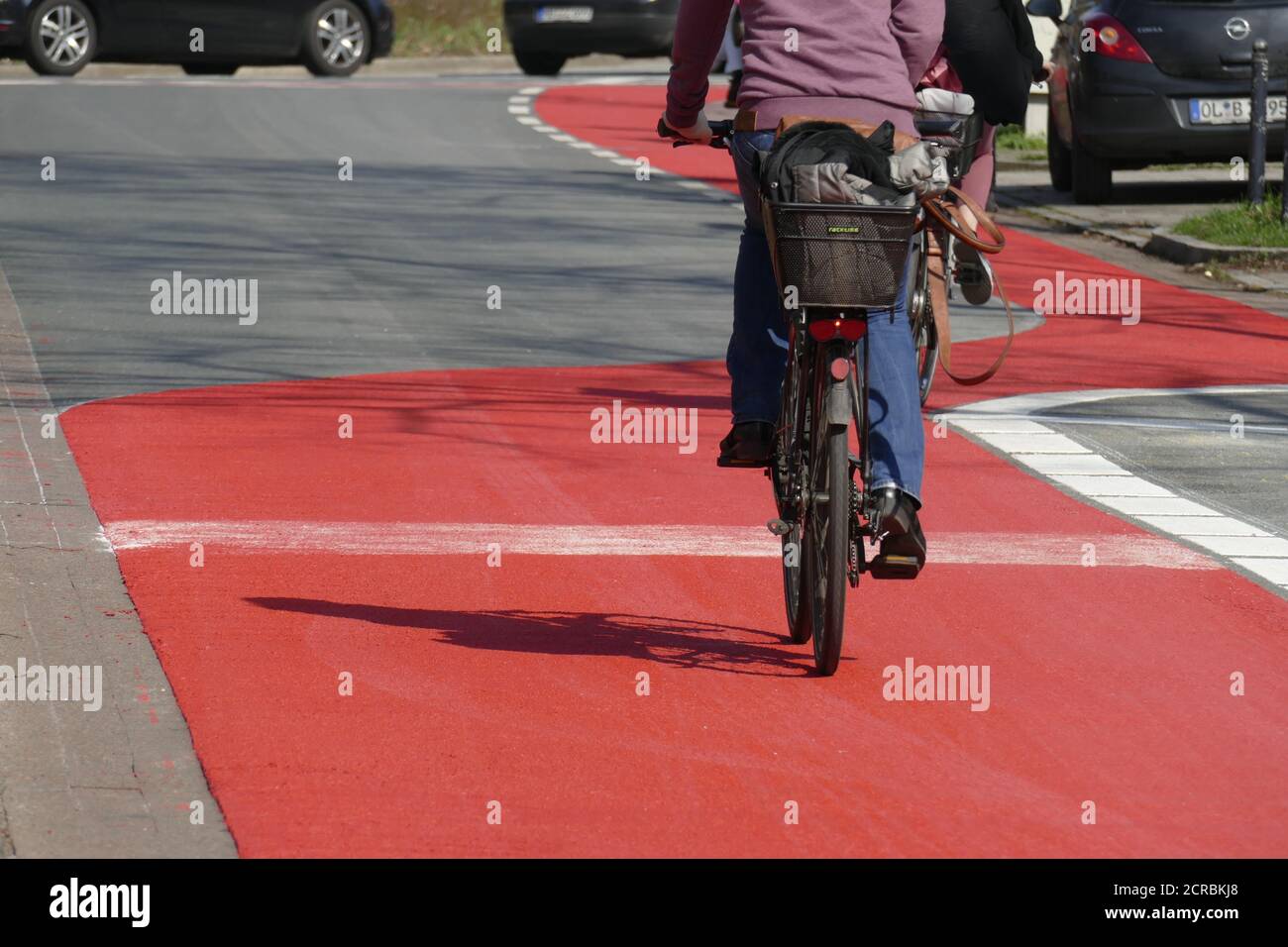 Red markings on the cycle path, freshly painted, red paint, Germany ...