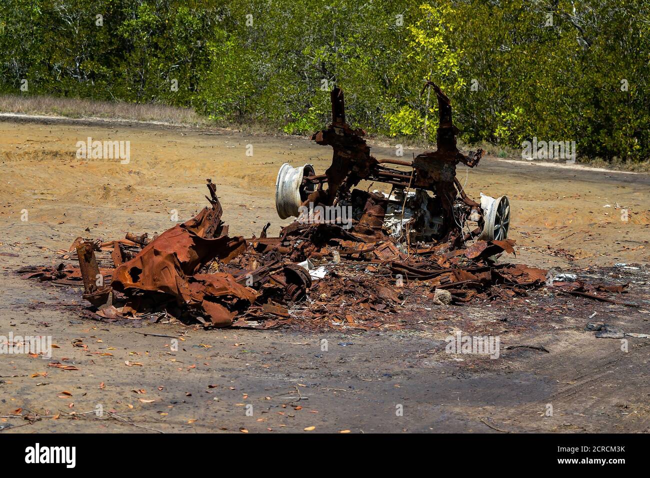 The rusted remains of a burnt out car chassis left abandoned on tidal ...