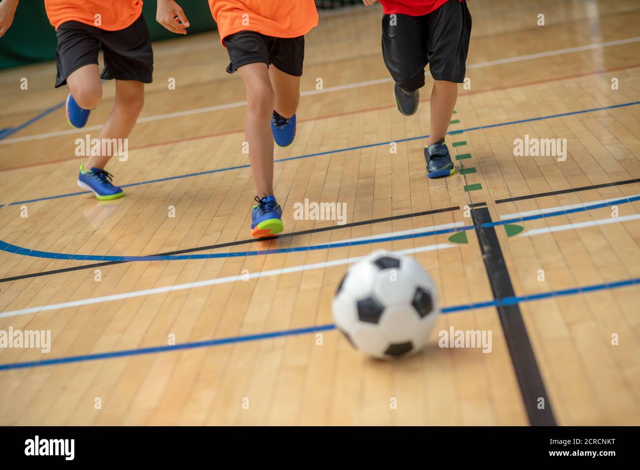 Children running after ball hi-res stock photography and images - Alamy