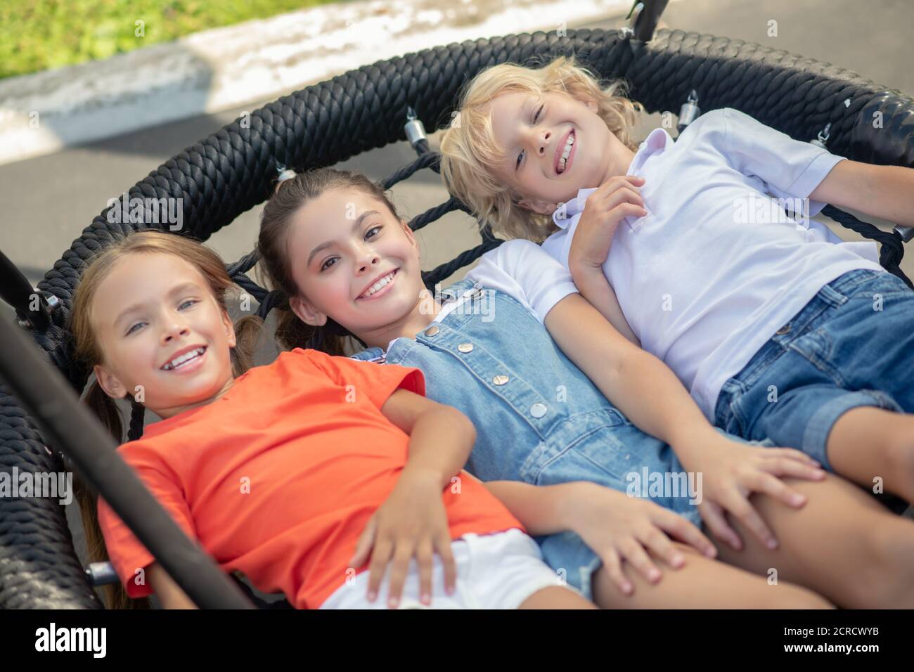 Kids resting after play and looking happy Stock Photo - Alamy