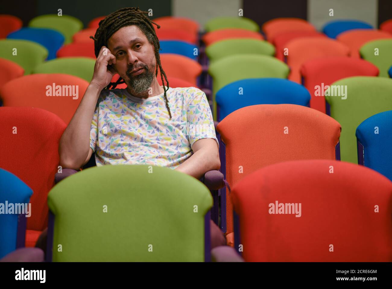 Colorful seating with man looking ahead Stock Photo - Alamy
