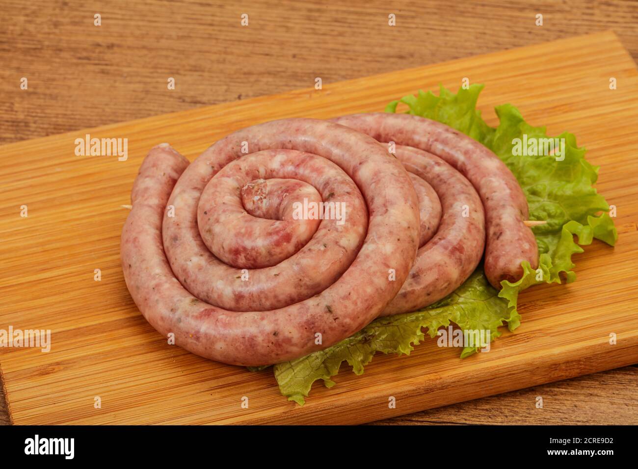 Raw pork sausage ring for grill Stock Photo - Alamy