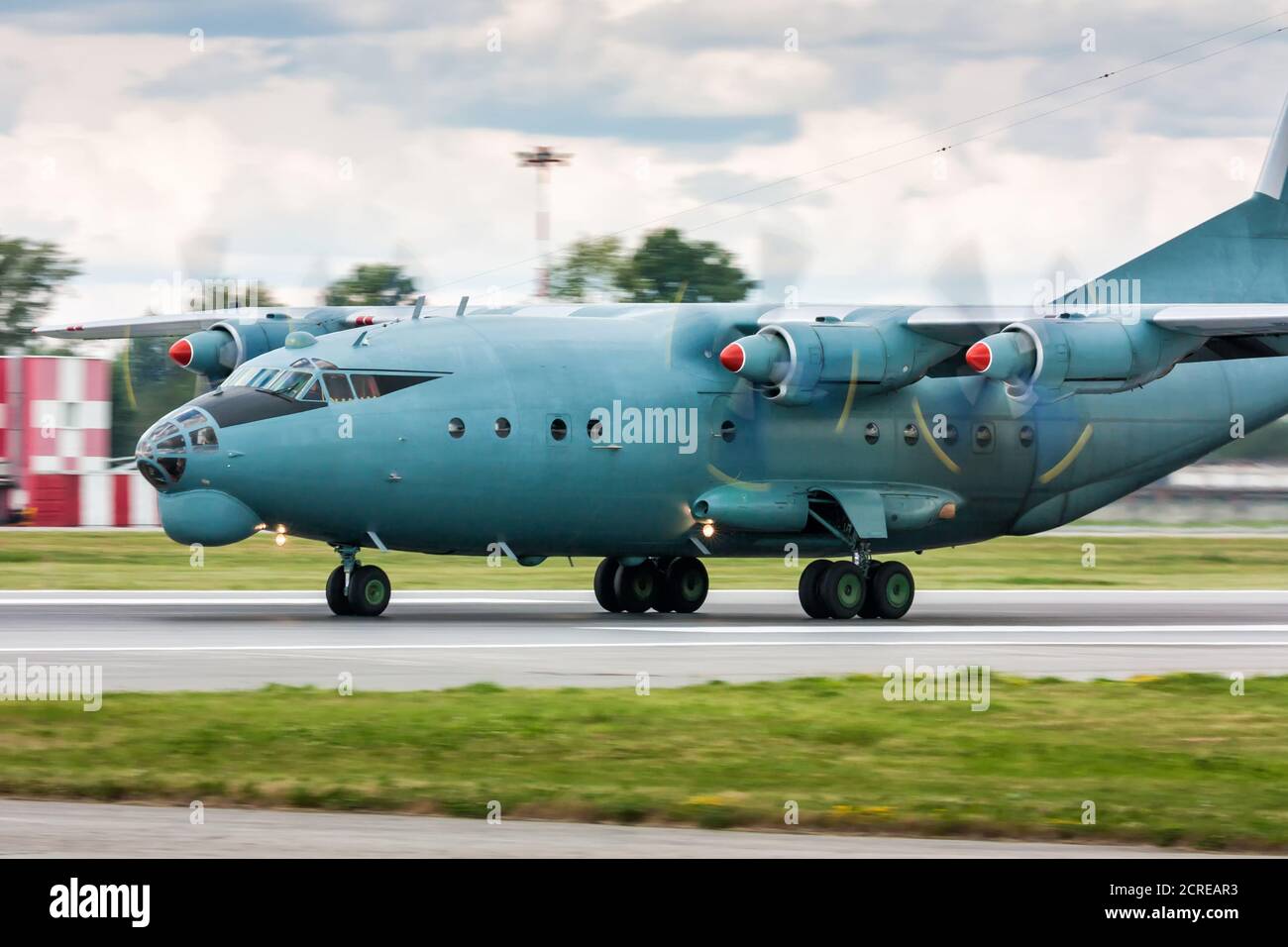 Four engine turboprop cargo aircraft heading on the runway Stock Photo - Alamy