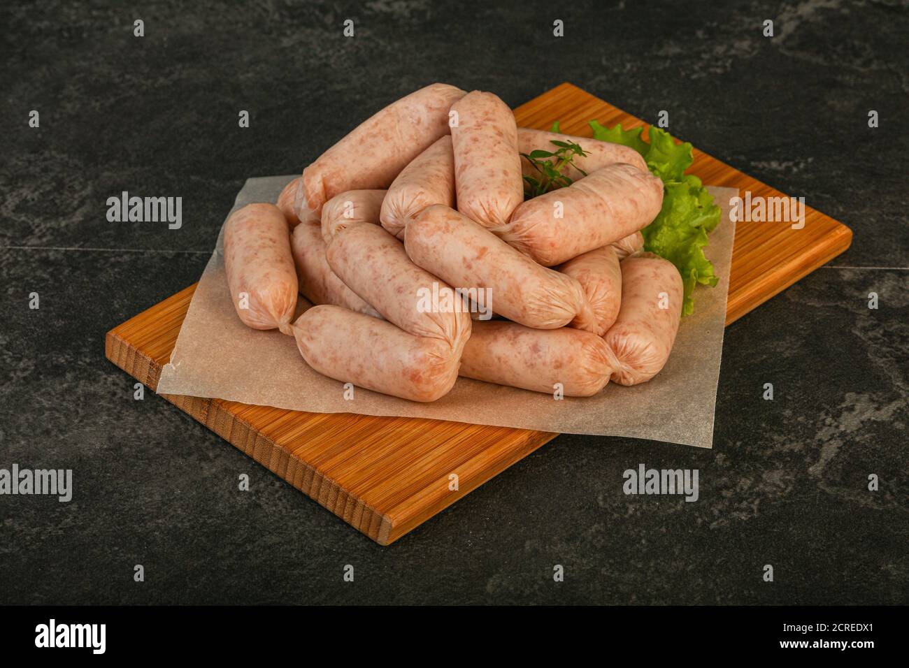 Raw natural chicken baby sausages for roast Stock Photo - Alamy