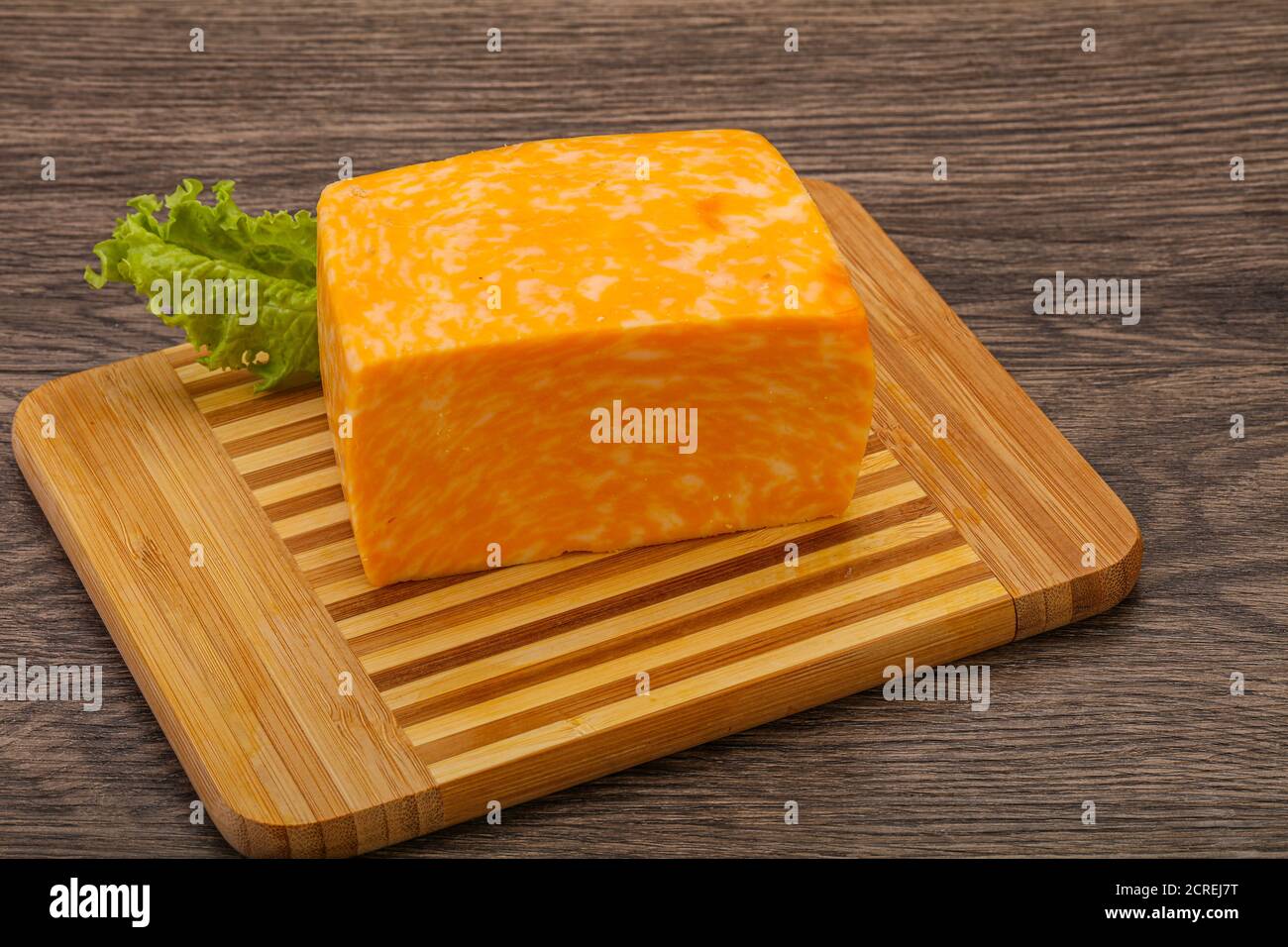 Dairy Marble cheese brick over board Stock Photo - Alamy