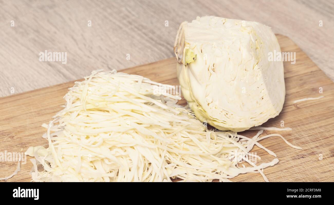 finely chopped cabbage closeup on wooden background Stock Photo - Alamy