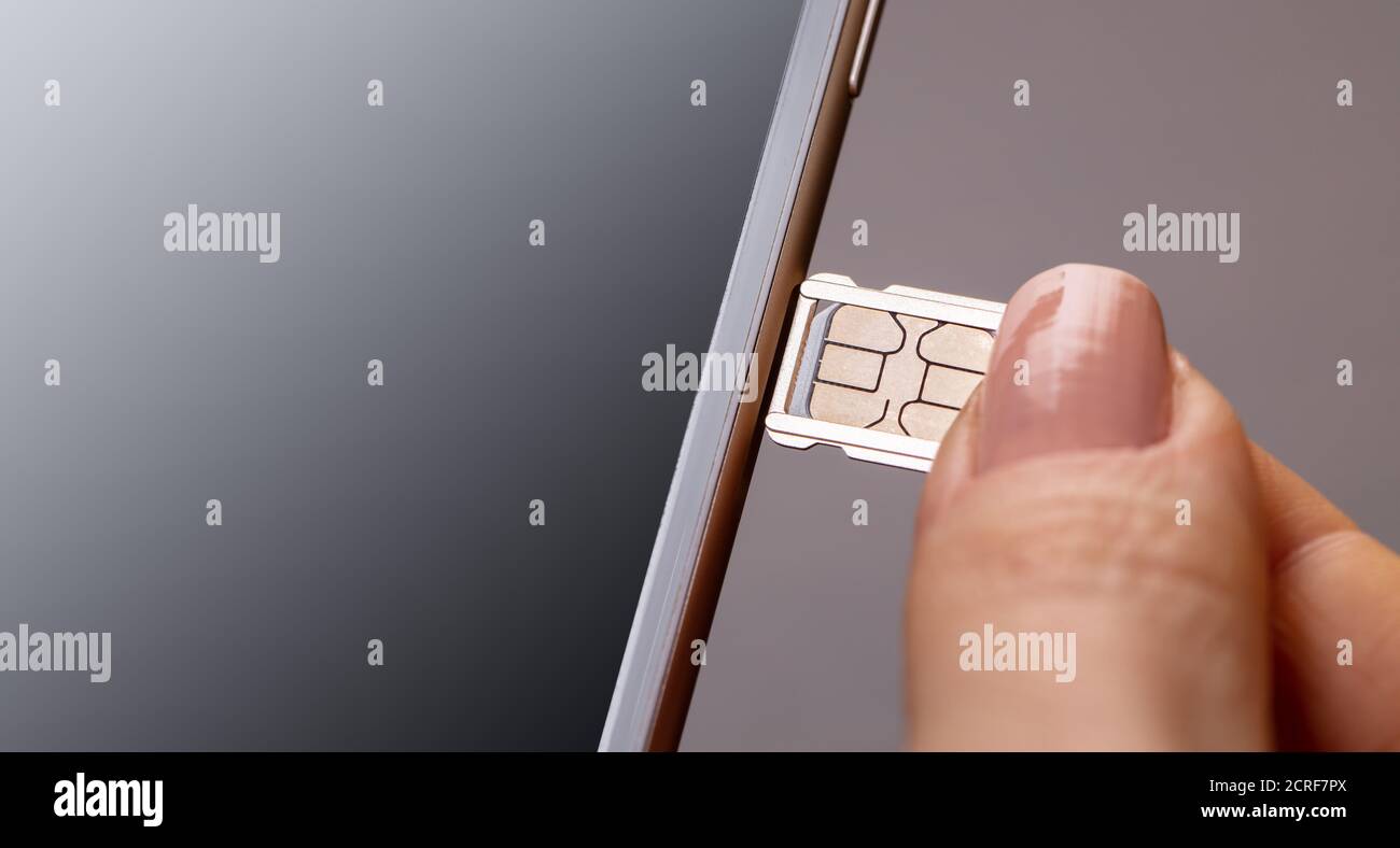sim card and mobile phone in female hands Stock Photo - Alamy