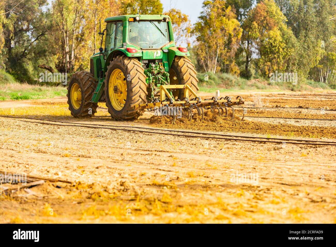 rural landscape, tractor cultivates agricultural land Stock Photo - Alamy
