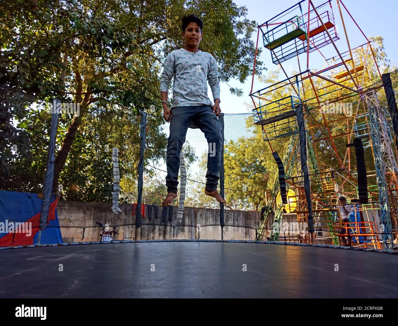 DISTRICT KATNI, INDIA - FEBRUARY 02, 2020: Indian village boy jumping ...