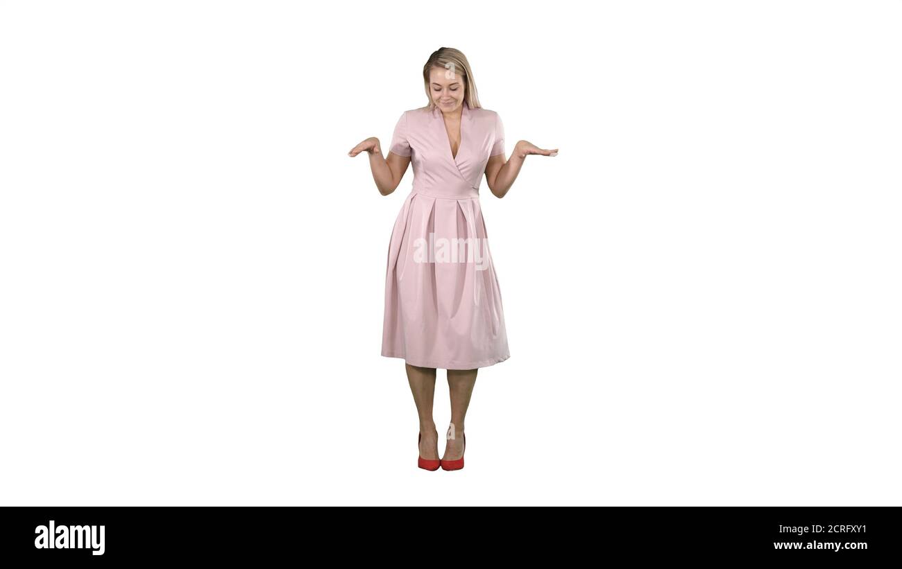 Blonde lady dancing in pink dress on white background Stock Photo - Alamy