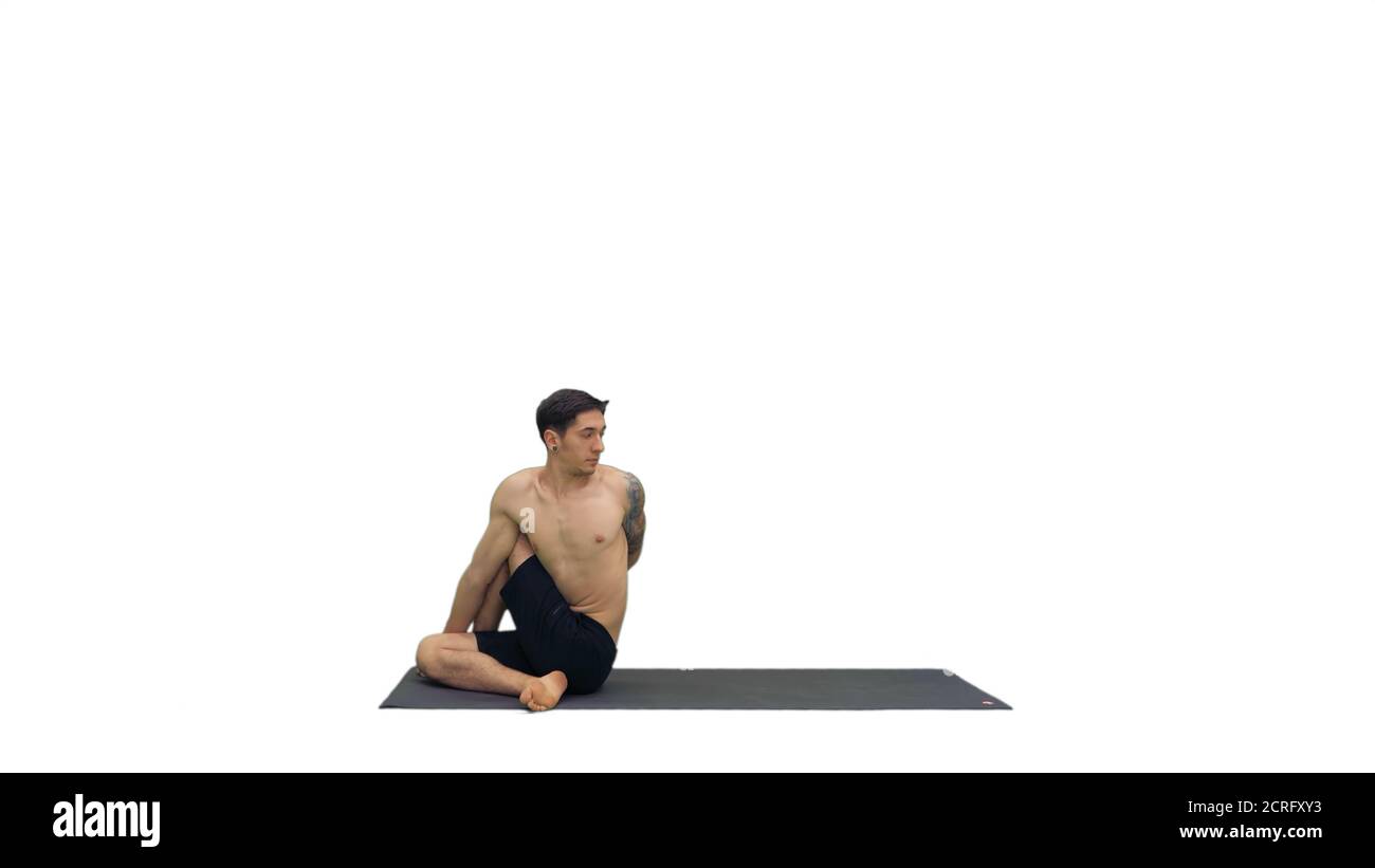 Man practicing yoga, stretching torso on white background Stock Photo ...