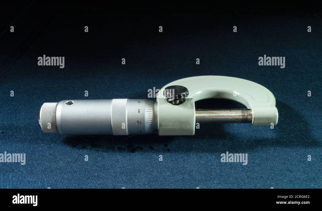 The Instrument micrometer on turn blue the table on black background ...