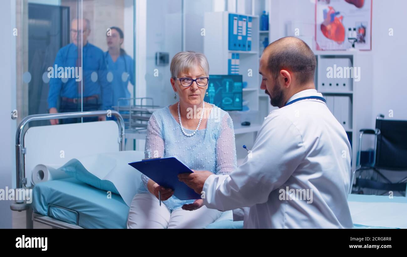 Doctor giving patient documents hi-res stock photography and images - Alamy