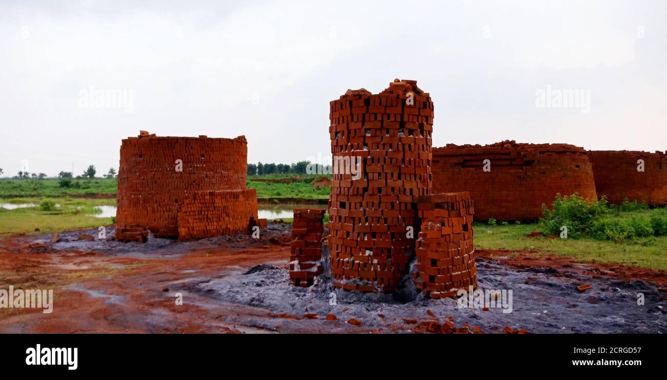 Red circular soil made bricks manufacturing with indian traditional ...