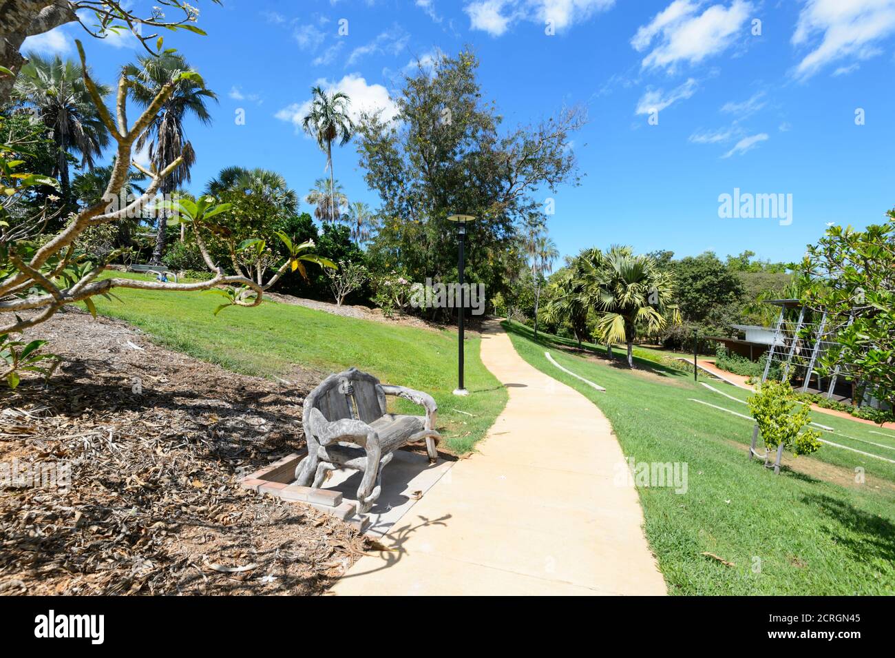 Rustic bench along a path at George Brown Darwin Botanic Gardens ...