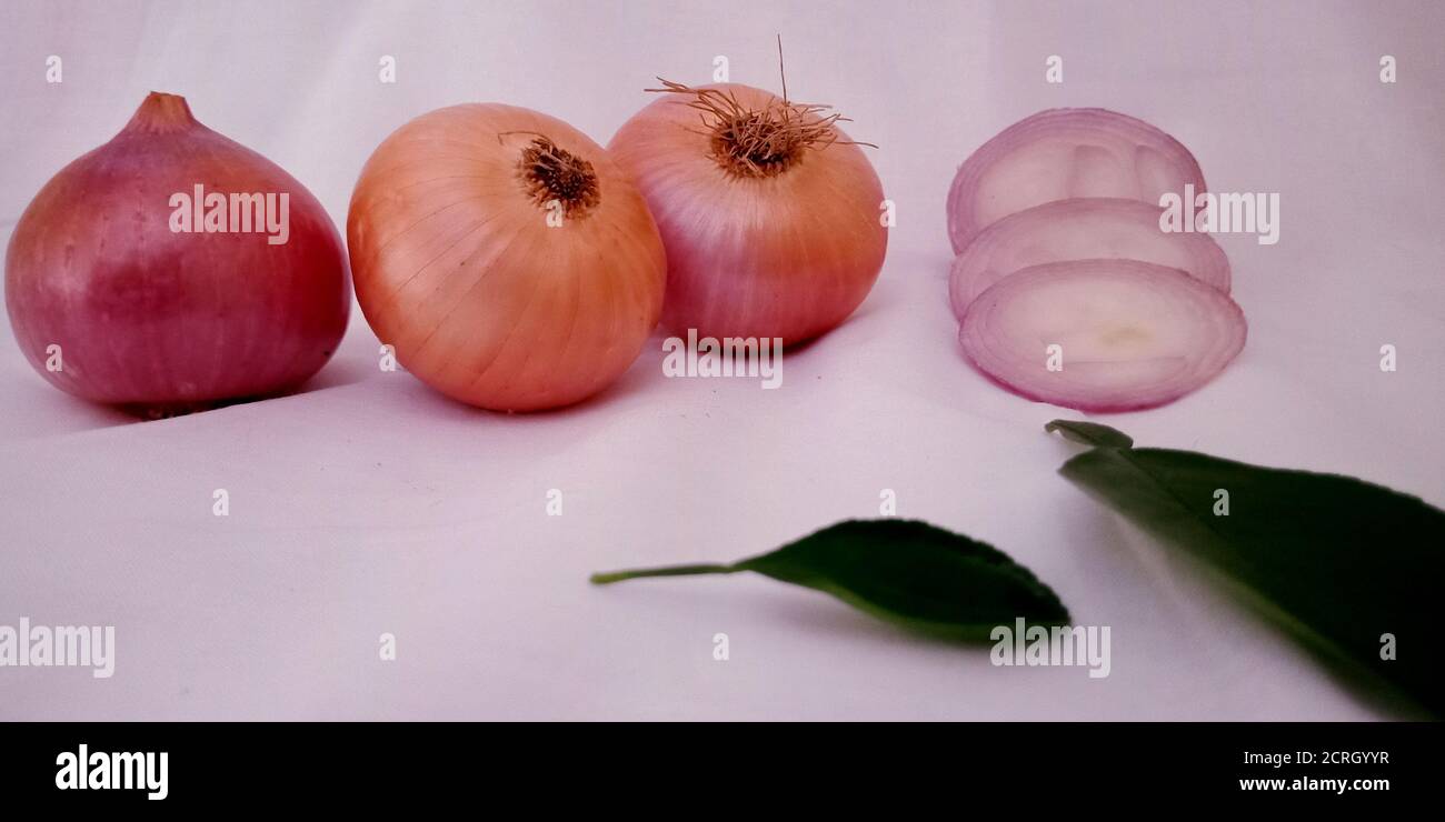 Fresh white color isolated double onion with set mixed green leaf for ...