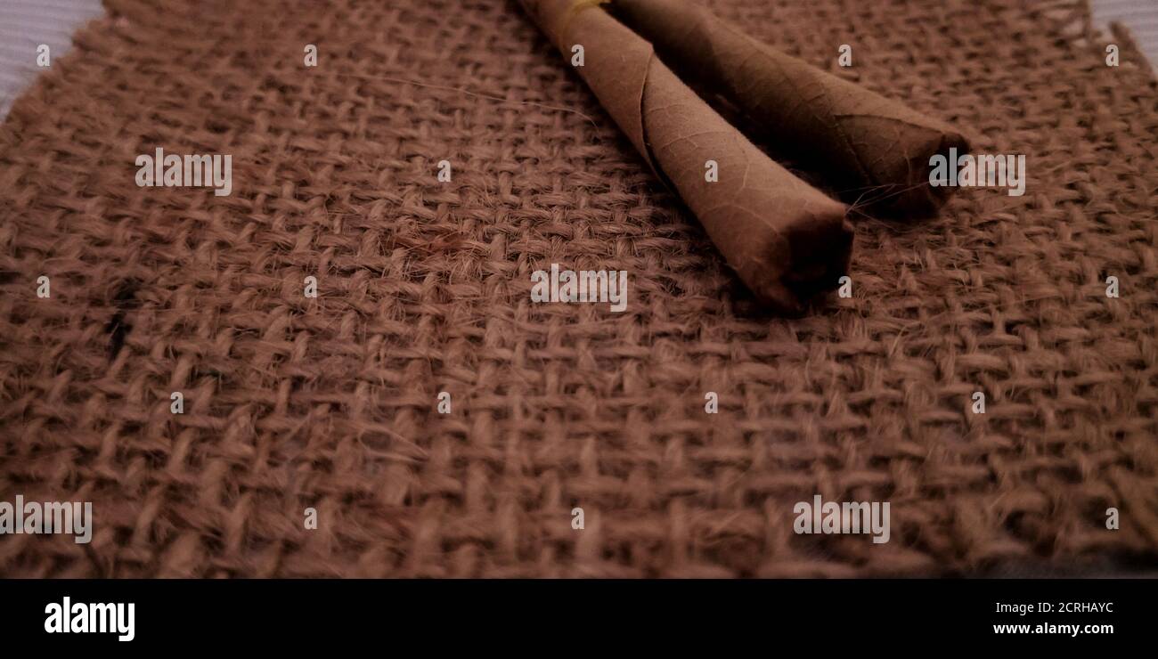 Indian traditional Bidi cigarette on brown sack mat background, pack of ...