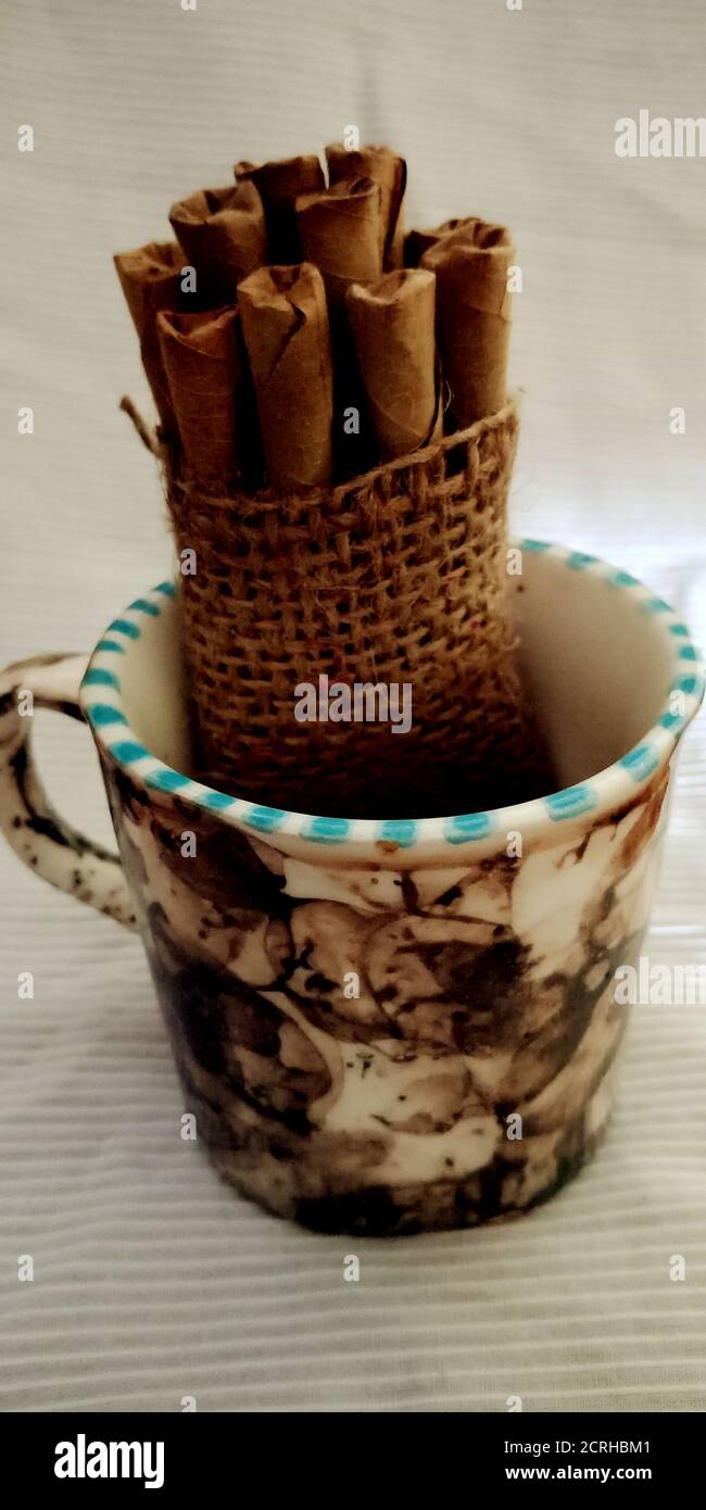 Cup of indian Bidi form of cigarette on brown sack mat background, pack ...