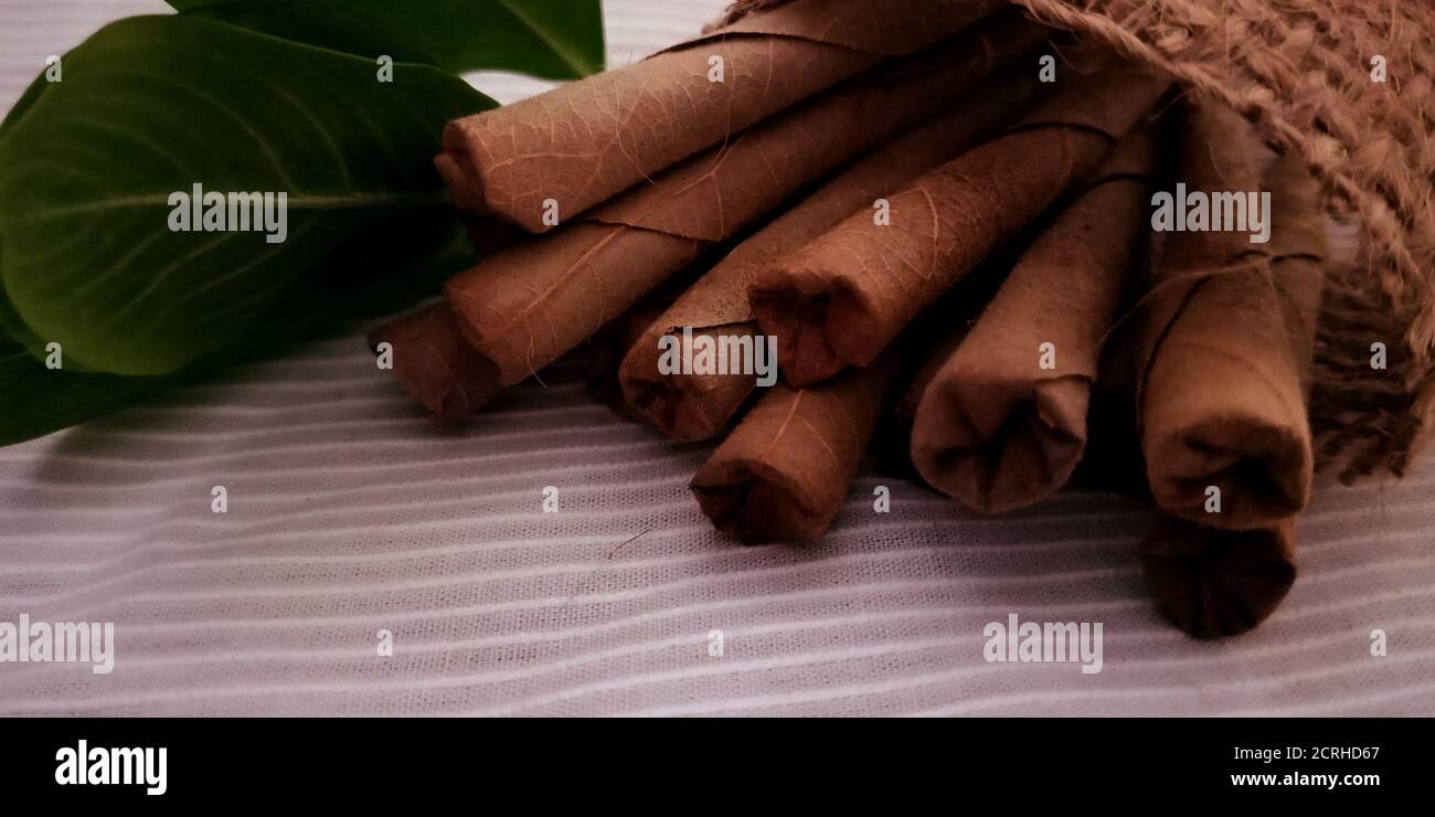 Bidi cigarette on brown sack mat background, pack of cigarettes, close ...