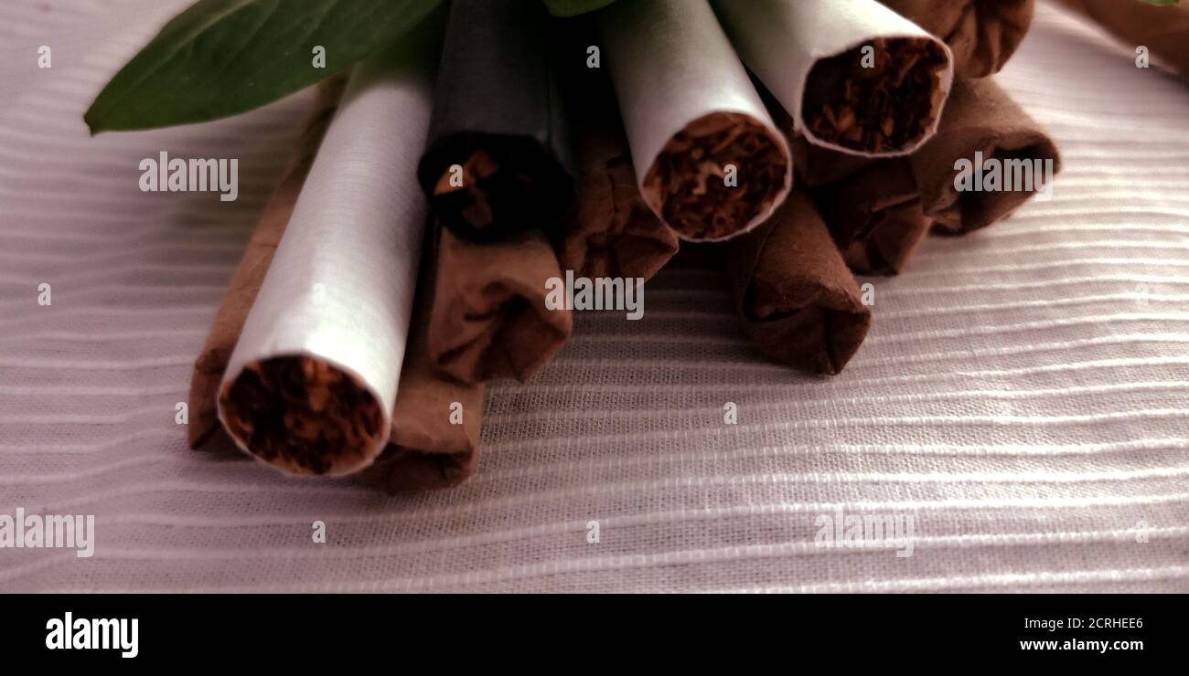 Black and white Bidi and cigarette on brown sack mat background, pack ...
