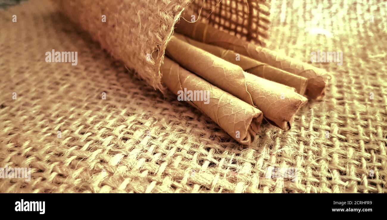 Indian traditional Bidi called cigarette on brown sack mat background ...