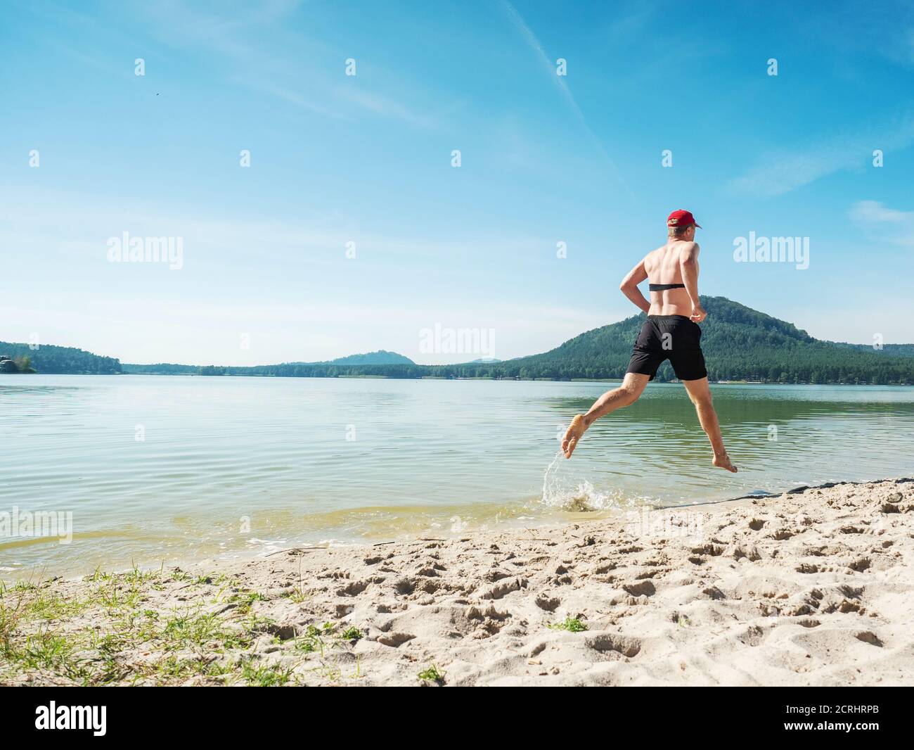 Man athlete checking heart activities during workout run exercise at ...