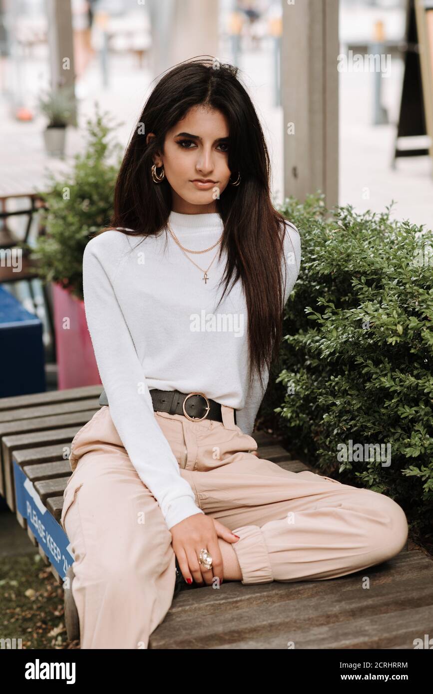 Vertical shot of an Asian young woman posing in the street Stock Photo ...