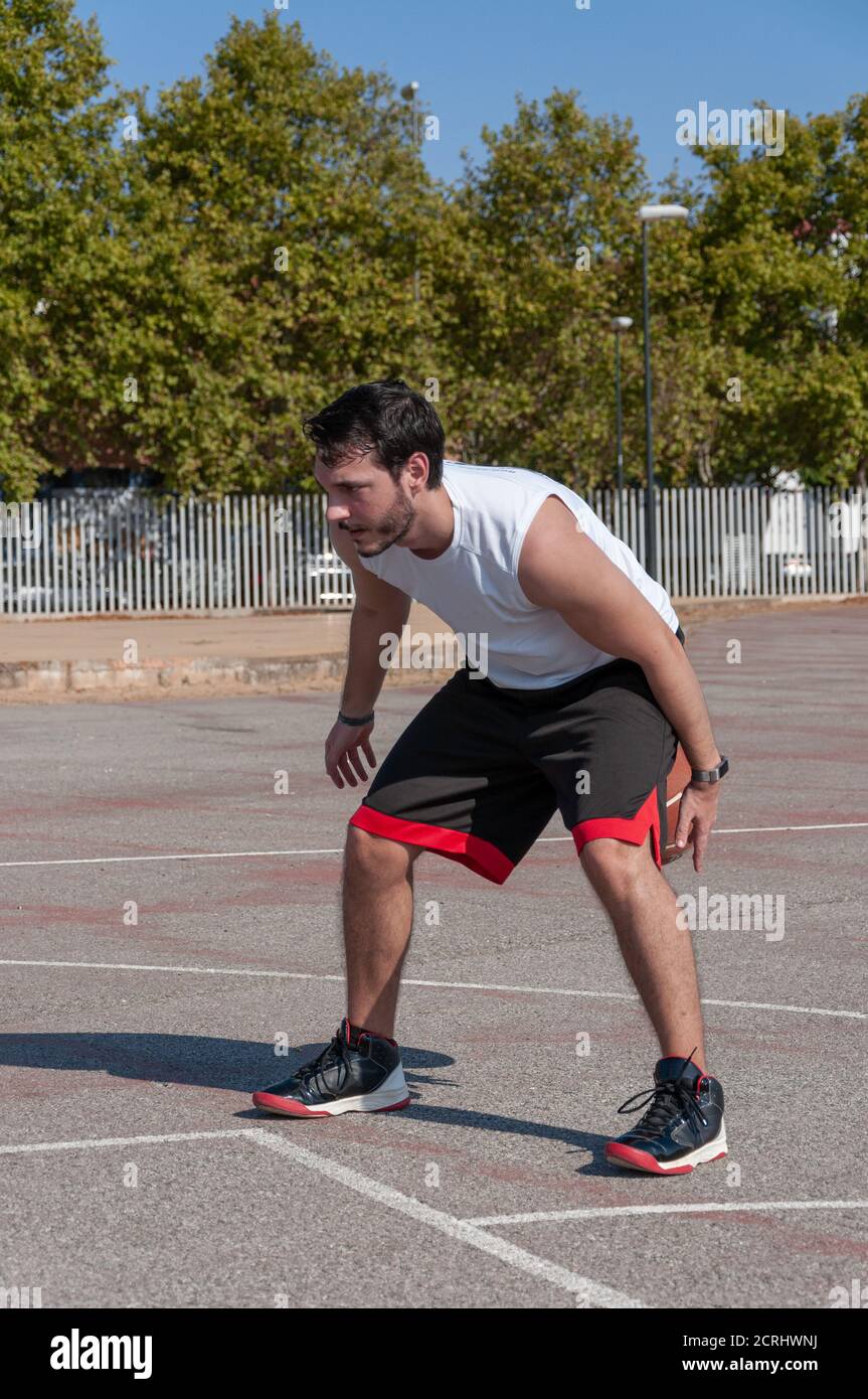 Closeup of an attractive in good shape guy playing basketball Stock ...