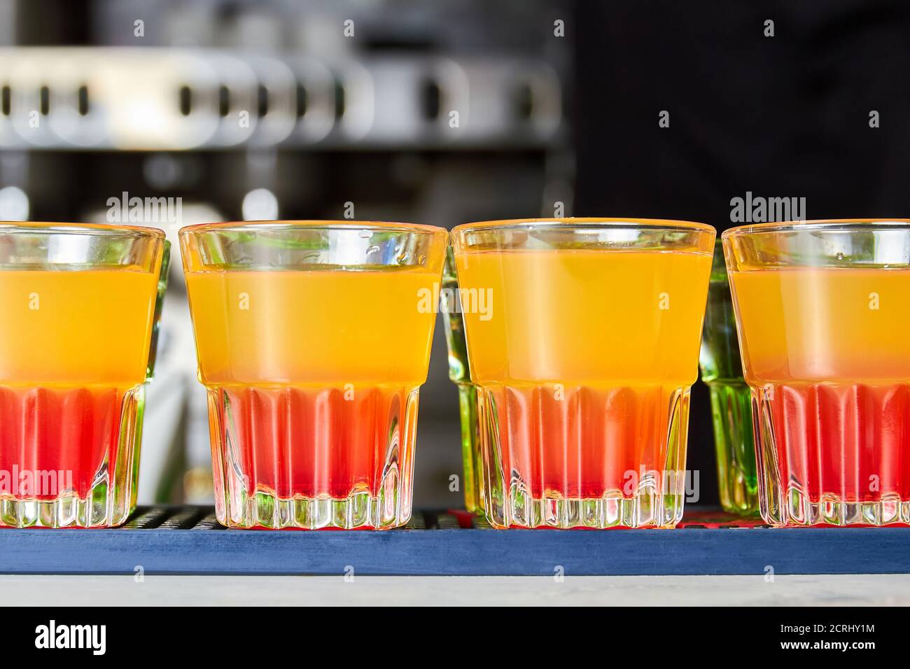 Several multicolored alcoholic drinks shots on the bar counter Stock ...