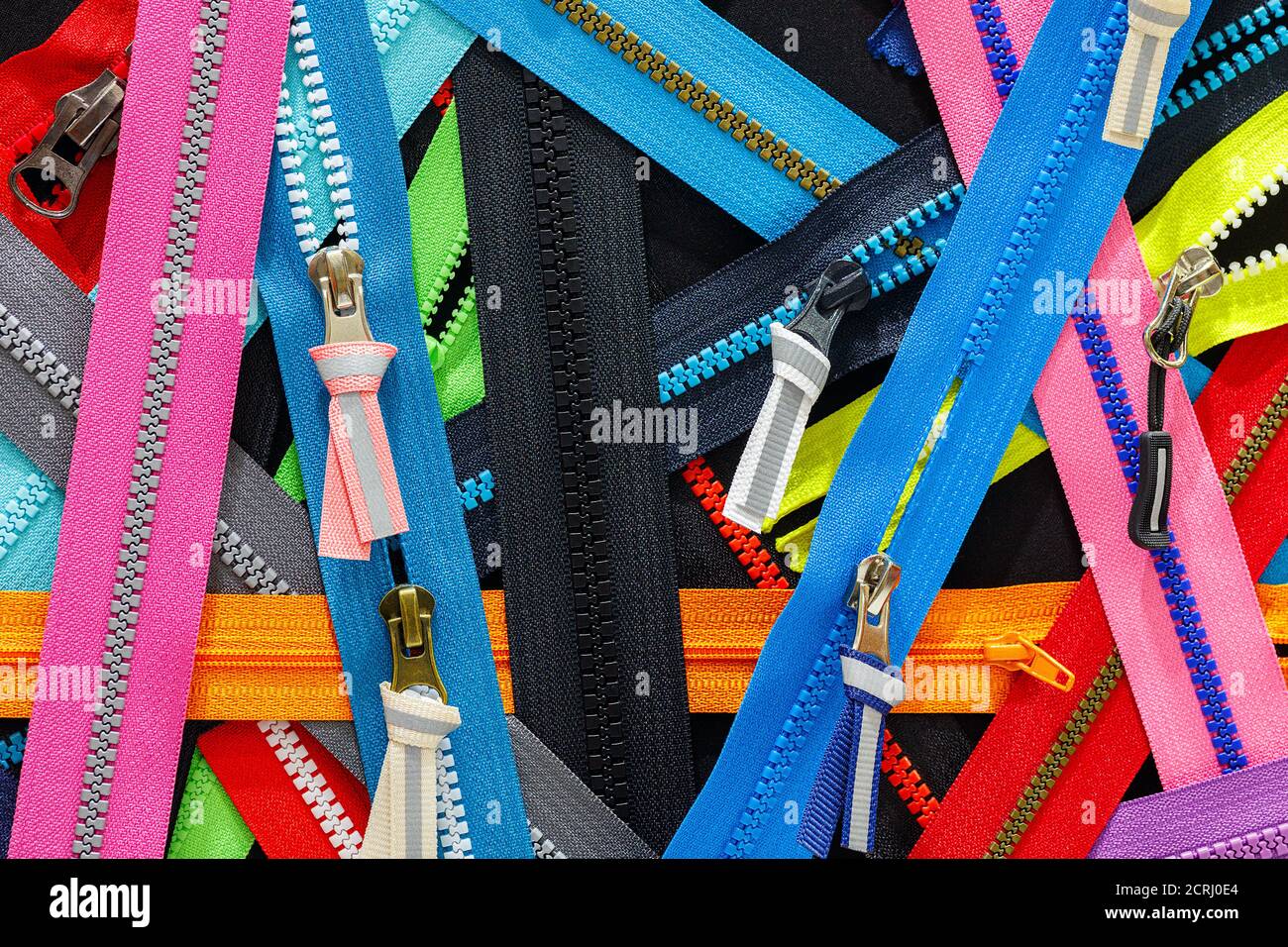 Zip background texture of zippers sliders. a lot of zippers in ...