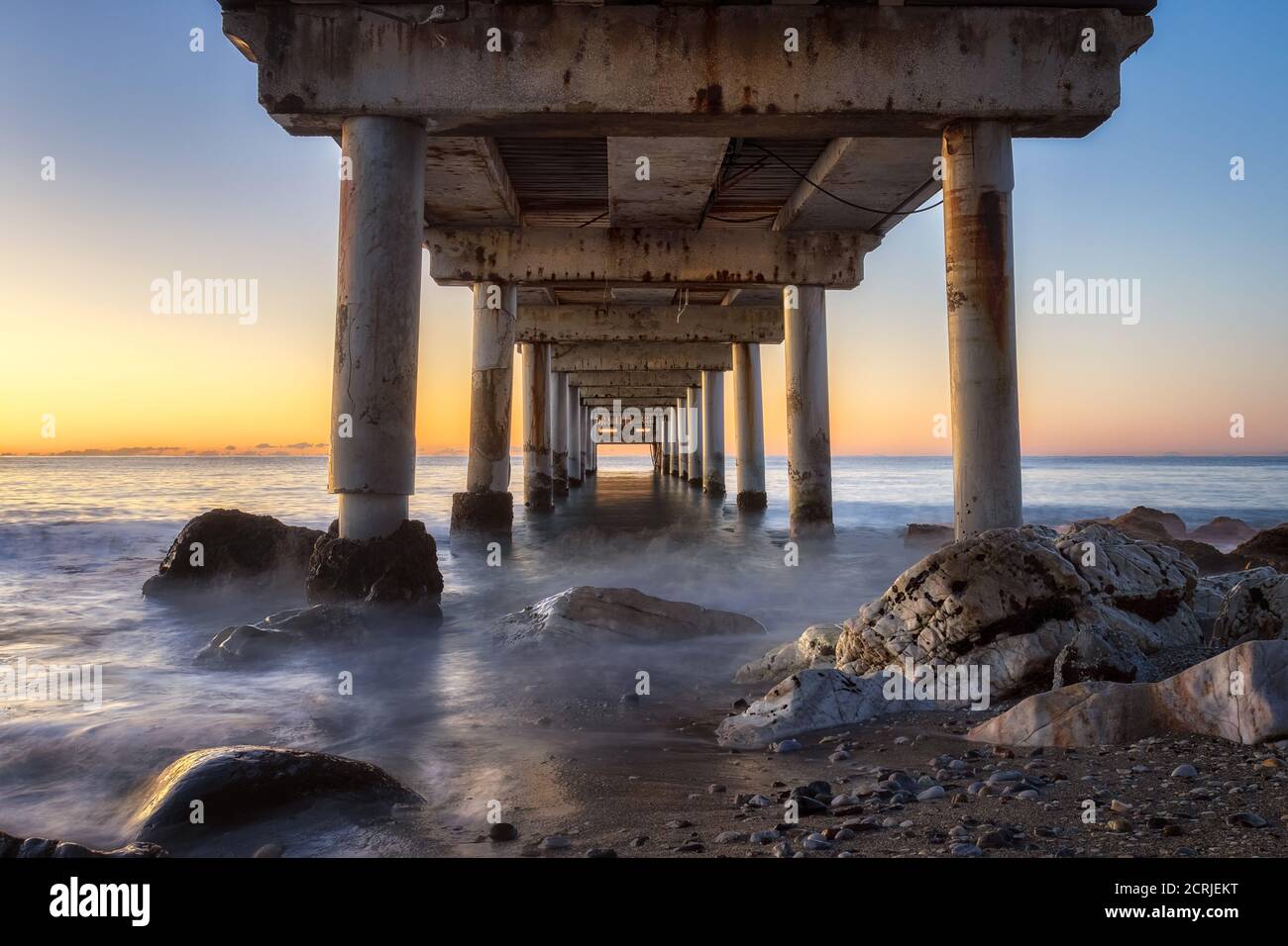 Low angle shot of a pier in Marbella, Spain during sunrise Stock Photo ...