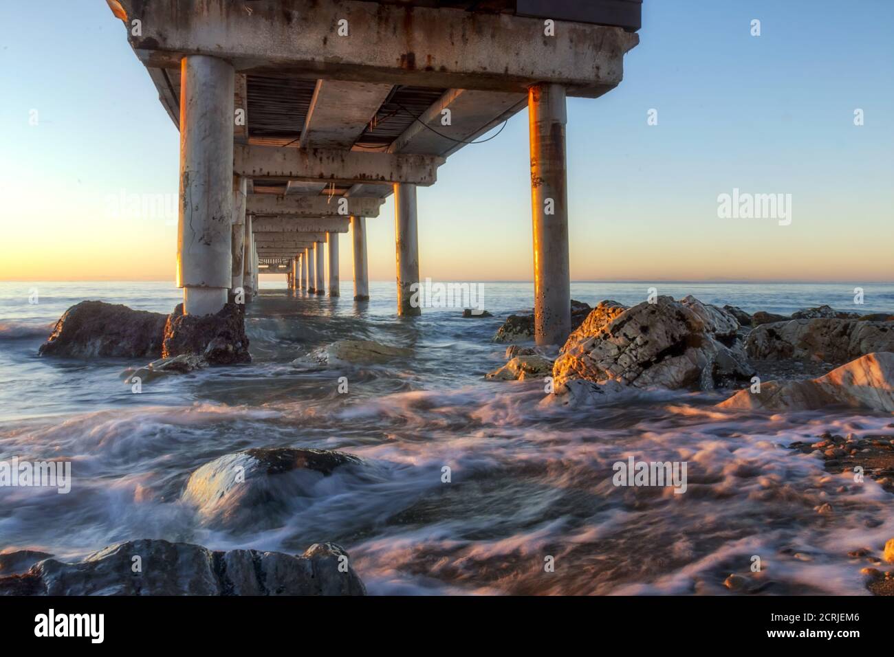 Low angle shot of a pier in Marbella, Spain during sunrise Stock Photo ...