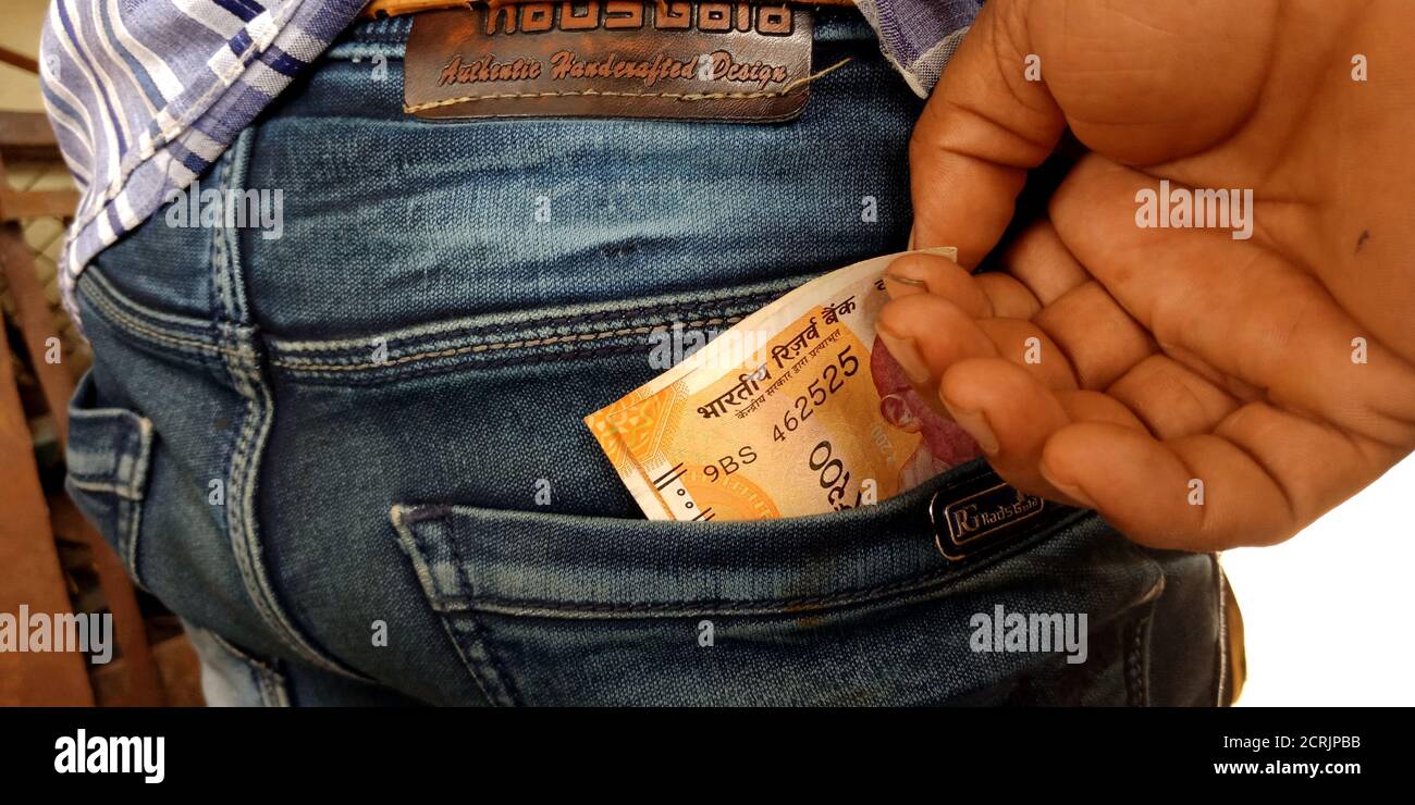 Man hand picking indian currency note from jeans pant back pocket Stock ...