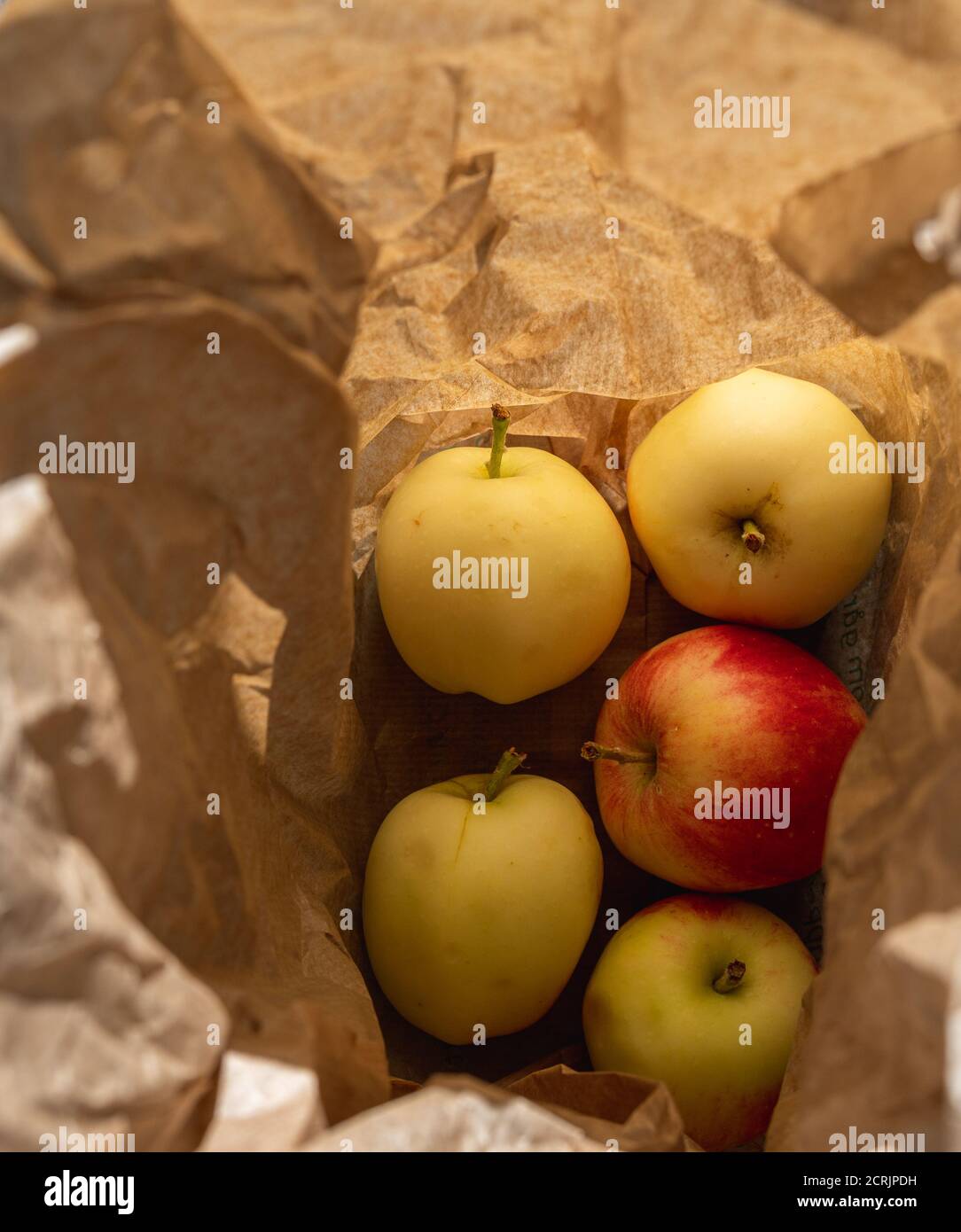 Green and red apples placed in a environment friendly paper bag Stock ...