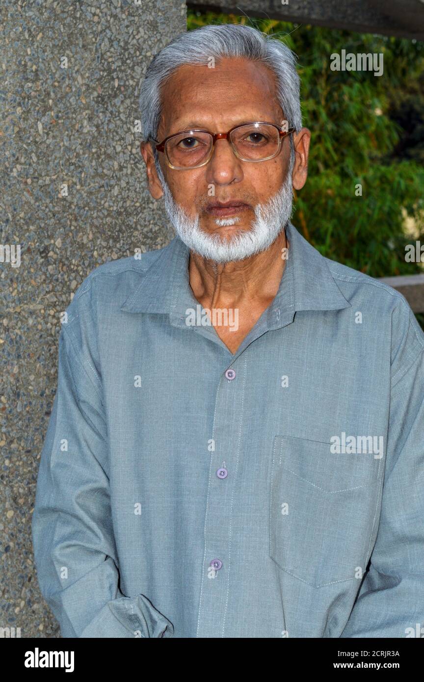A indian old age uncle poses for portfolio shoot at outside of studio ...