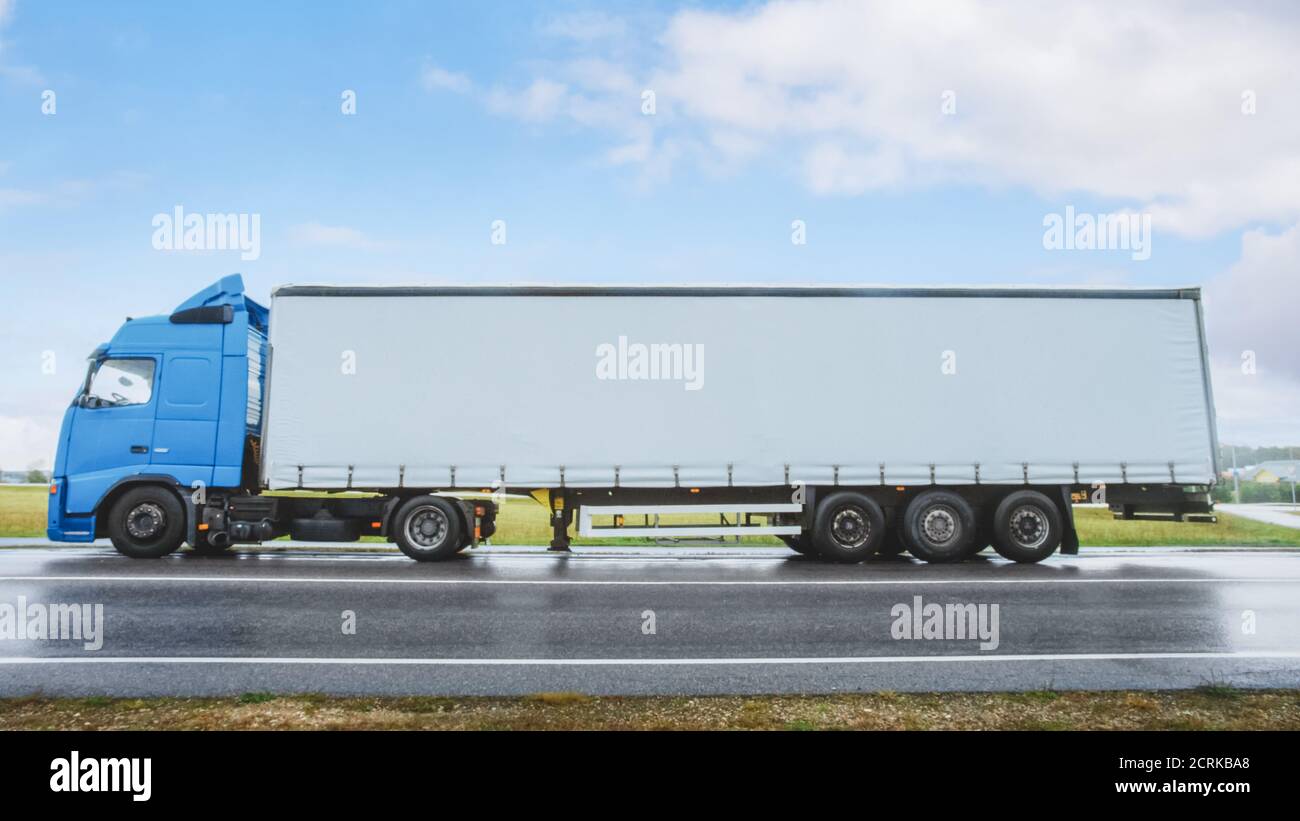 Side View Shot of a Blue Long Haul Semi-Truck with Cargo Trailer ...