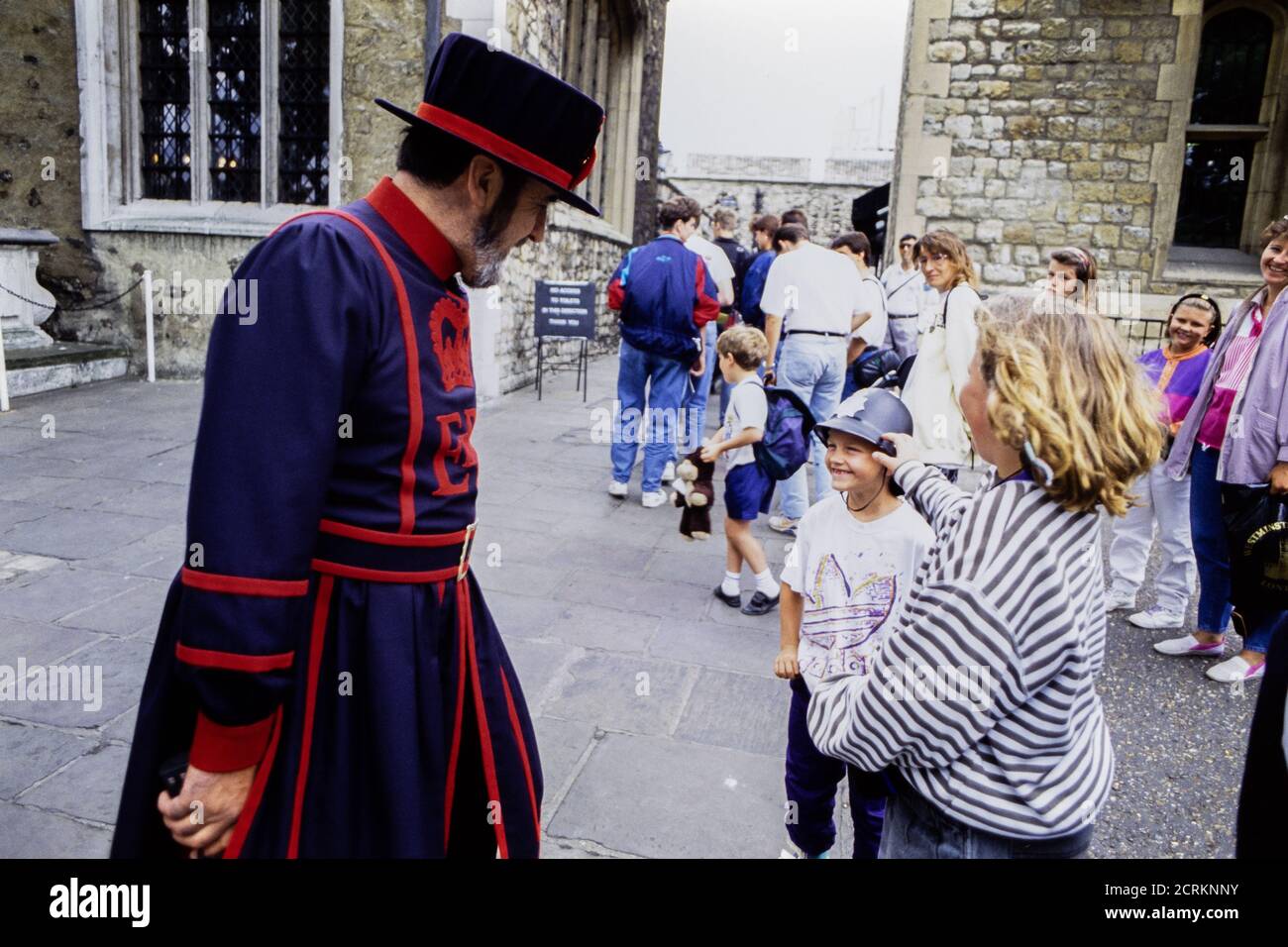 Yeoman Warder at The Tower of London on duty with school children and ...