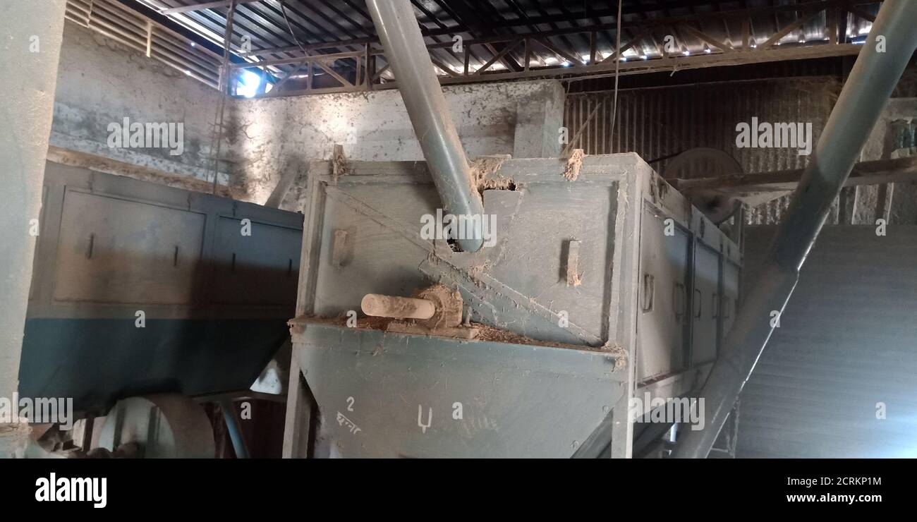 an old rusty rice mill machinery pipe supply tool exposed to the dusty ...