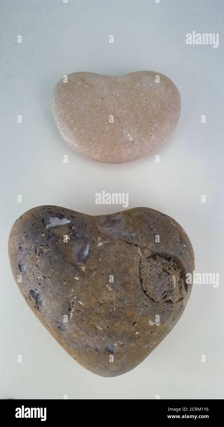 Two hearts made from different stones with a white background Stock ...