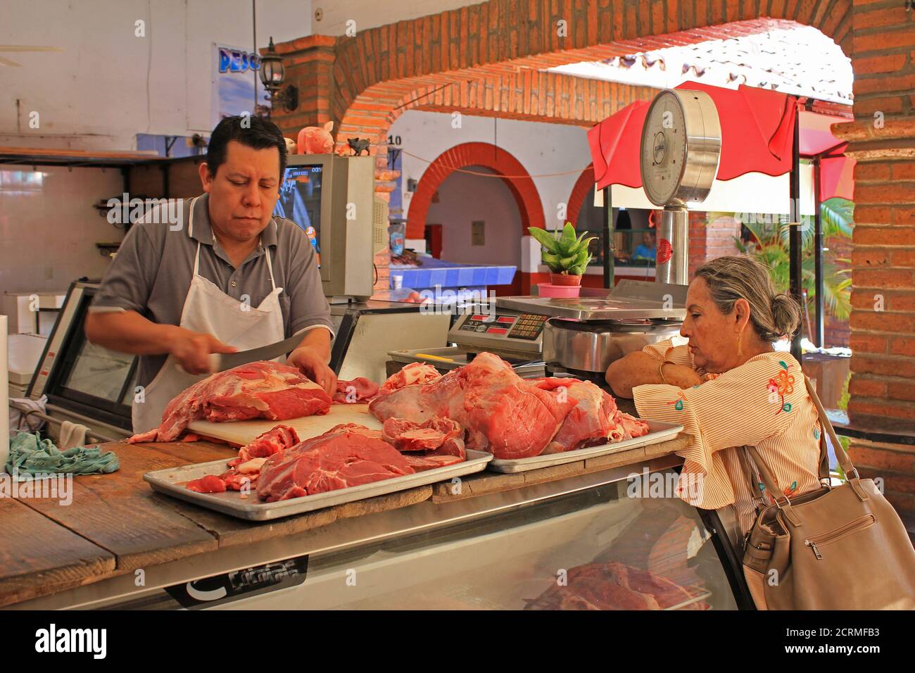 Stylish lady buying meat at the butcher shop Stock Photo - Alamy