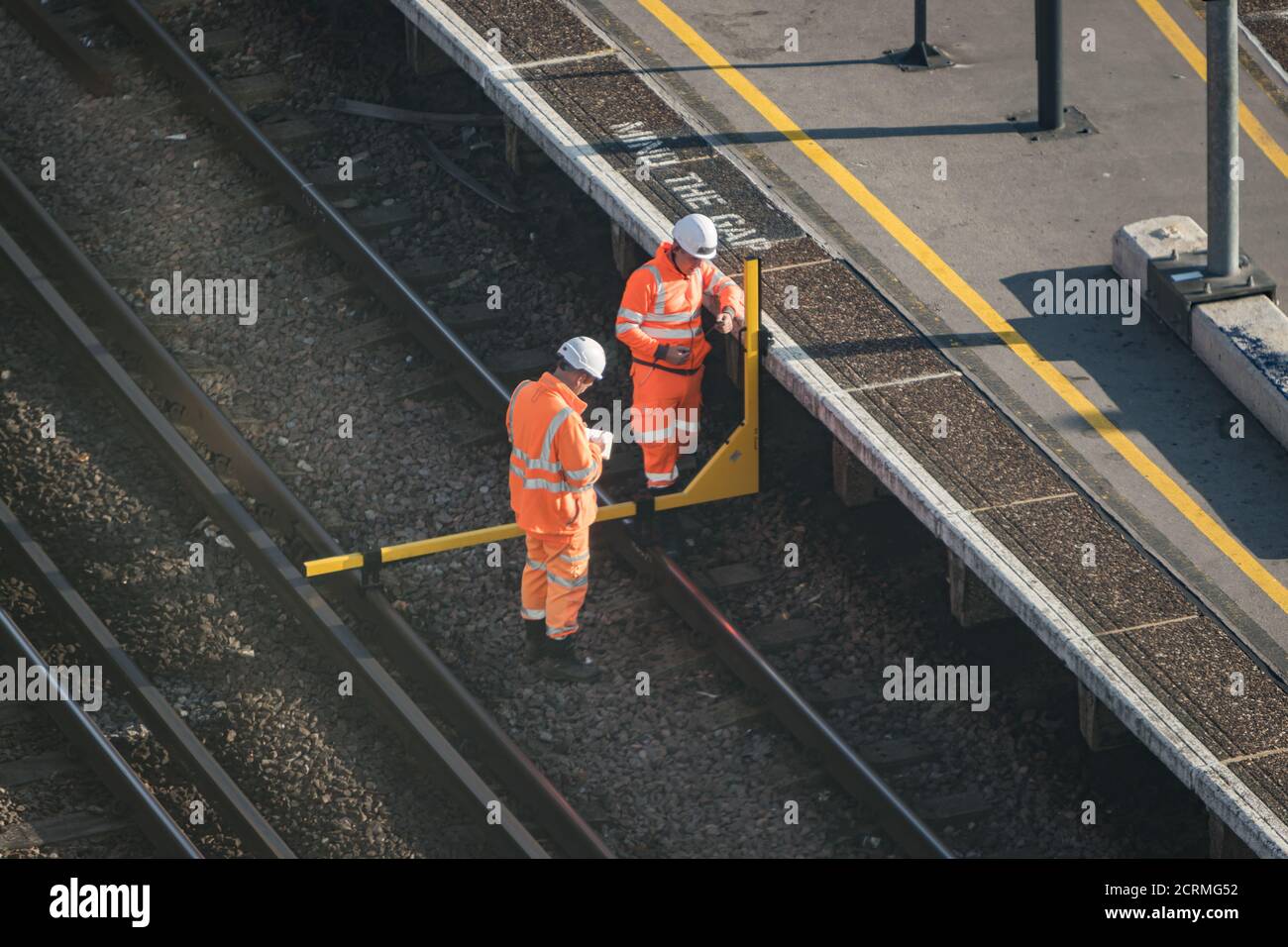 Railway workers using a loading gauge profile measuring device Stock ...