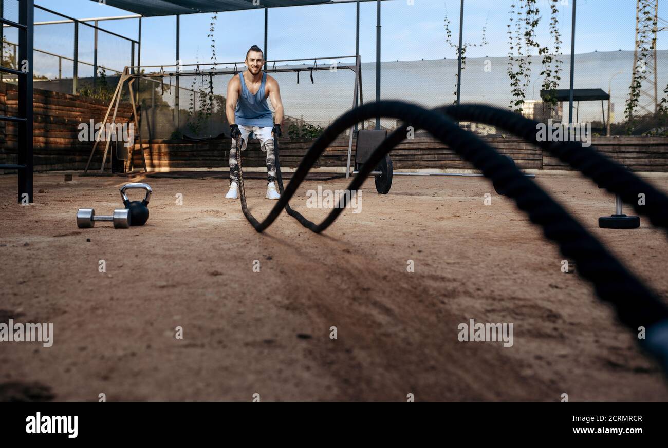 Man doing exercise with ropes, workout, crossfit Stock Photo - Alamy