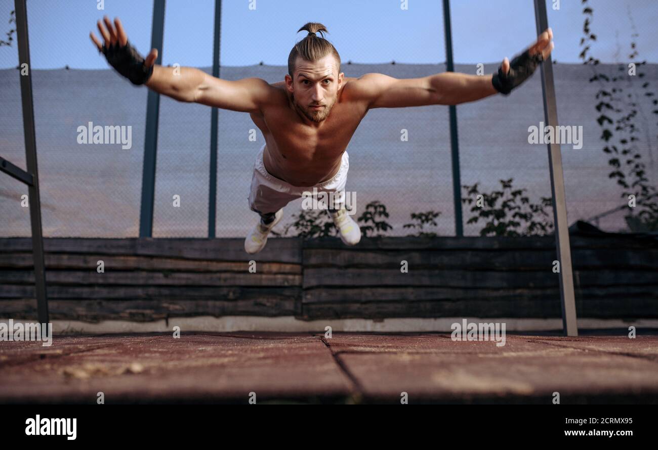 Athletic man doing push-up exercise with jumps Stock Photo - Alamy