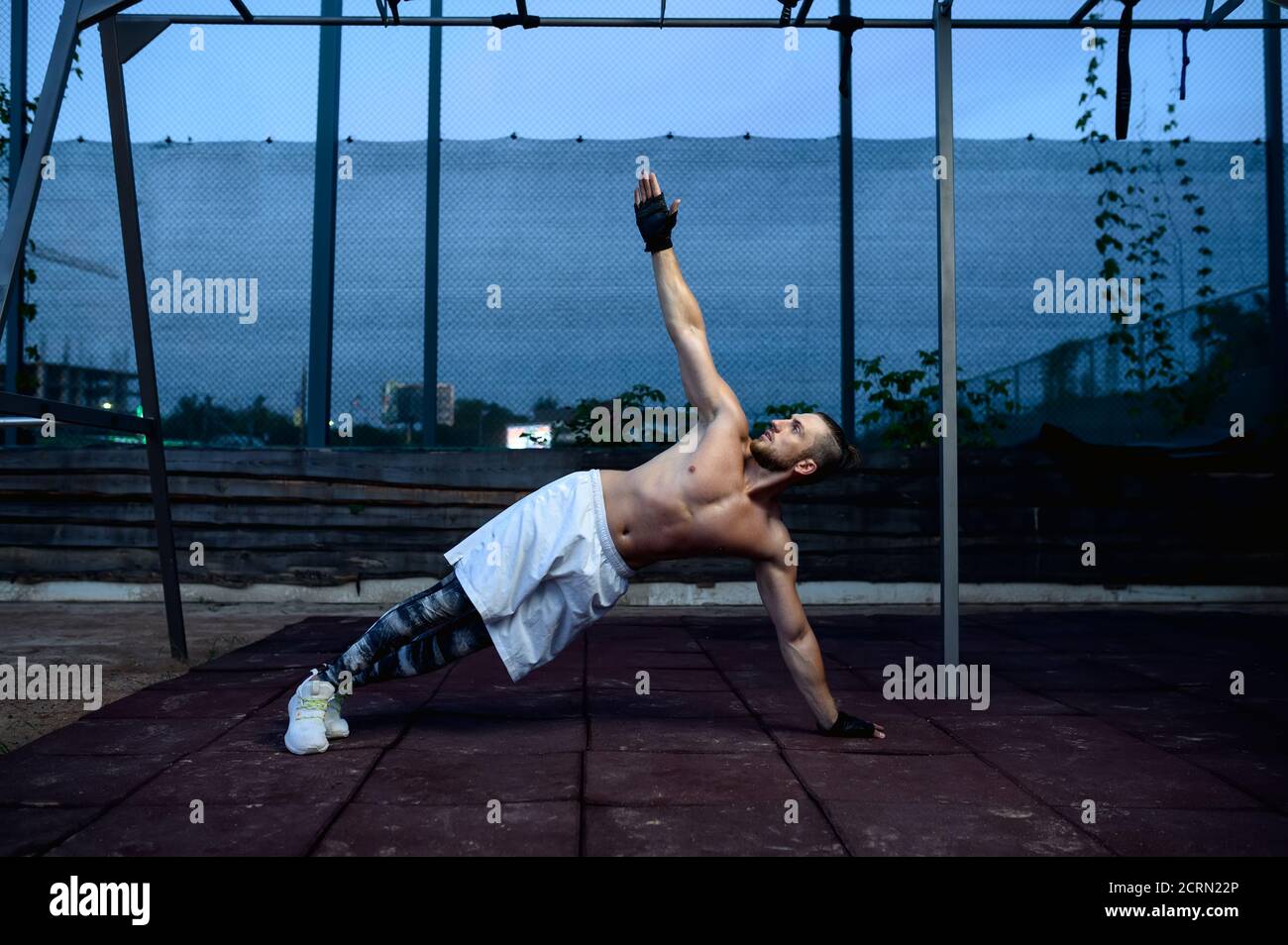 Strong man doing stretch exercise, street workout Stock Photo - Alamy
