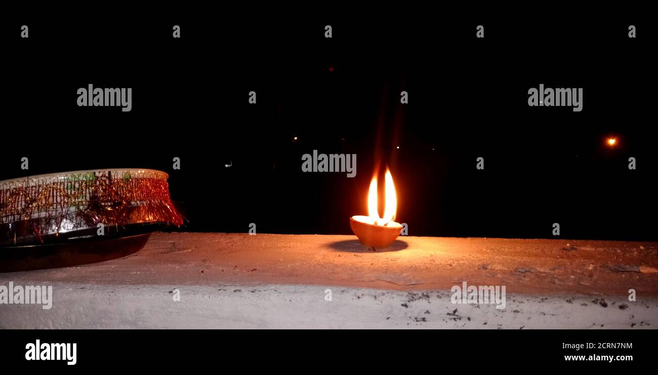 Soil lamp called Diya in hindi burning on night dark background Stock ...