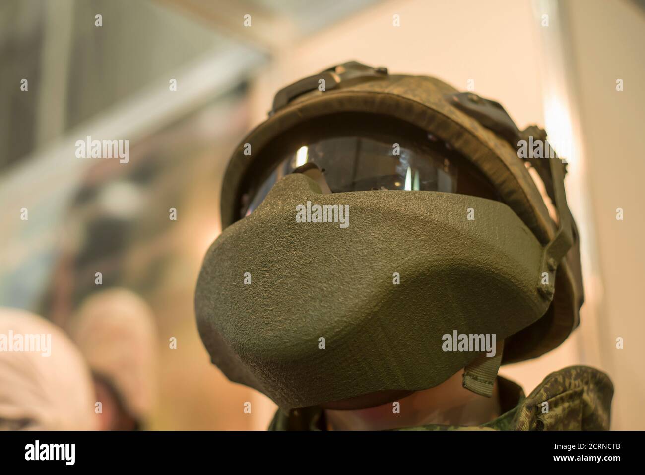 A modern army protective helmet, goggles and a protective mask at the ...